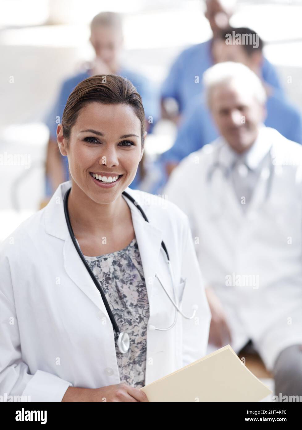 Looking after all your medical needs. A doctor standing with colleagues ...