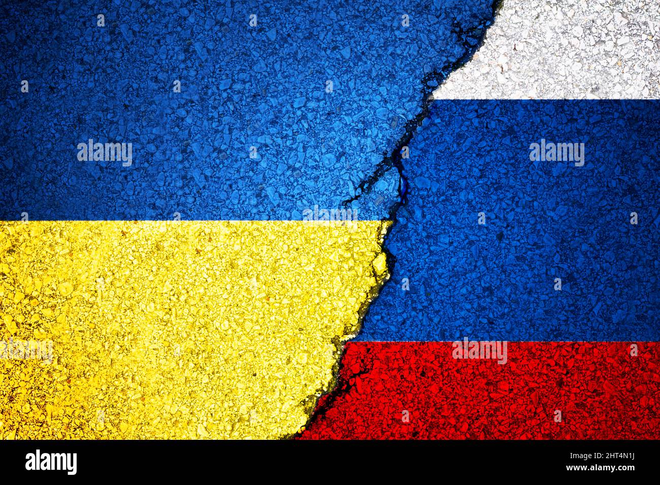Russia and Ukraine painted flags on a wall with a crack , war ...
