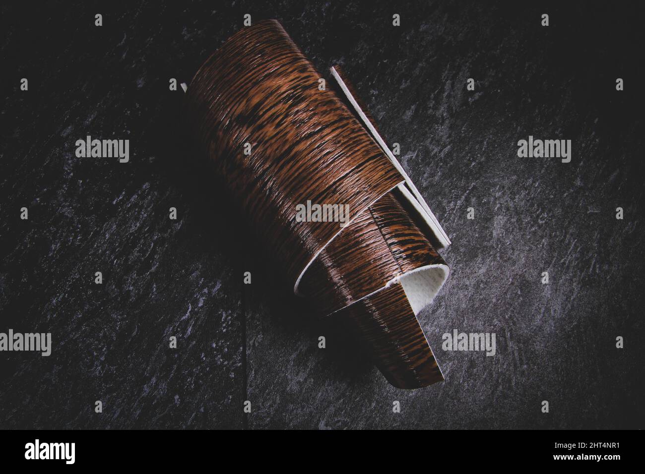 Linoleum. Roll of linoleum on a black background. Floor coverings ...