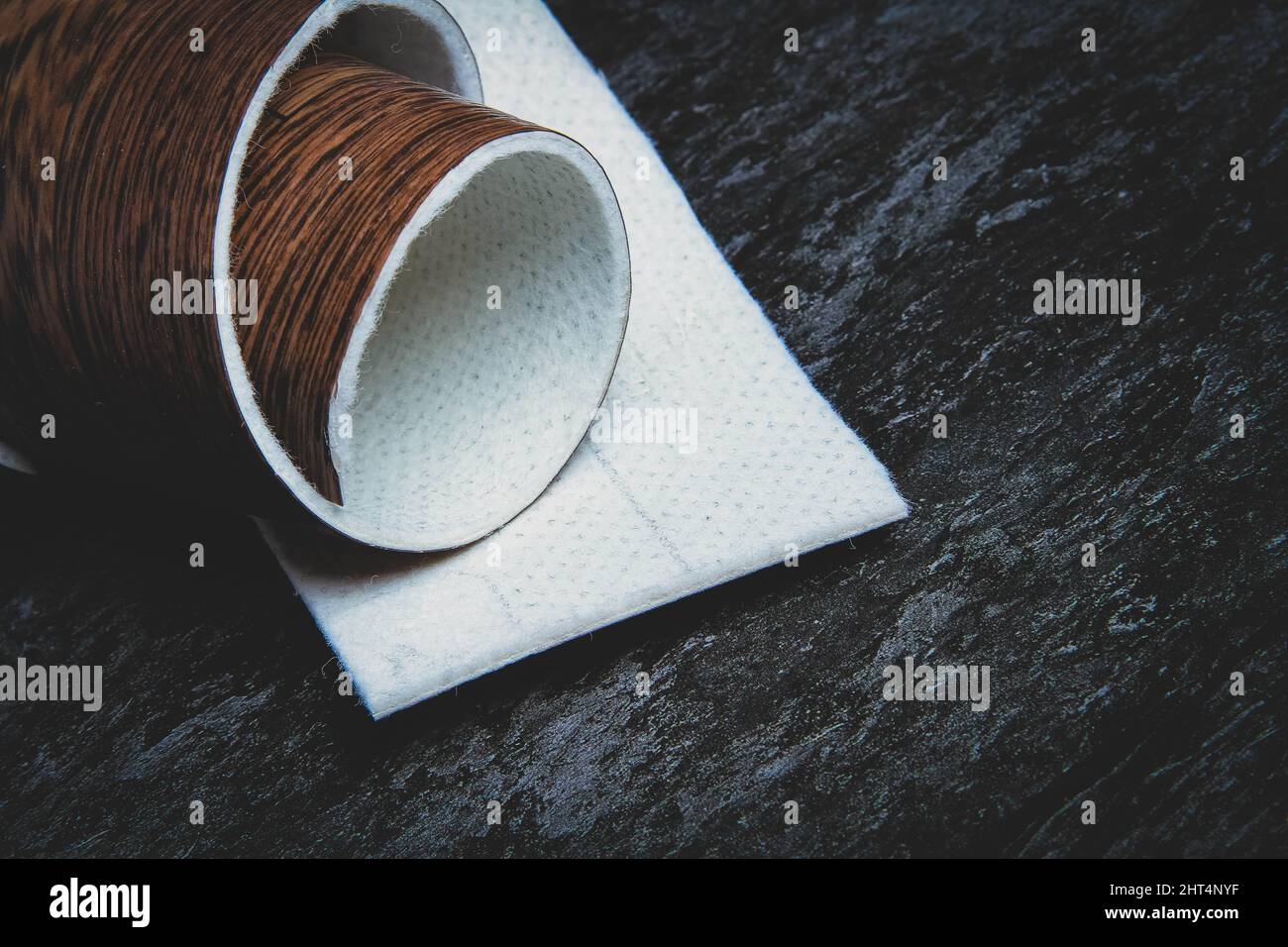 Linoleum. Roll of linoleum on a black background. Floor coverings ...