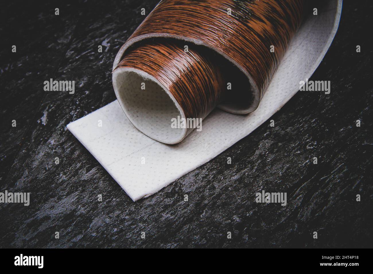 Linoleum. Roll of linoleum on a black background. Floor coverings ...