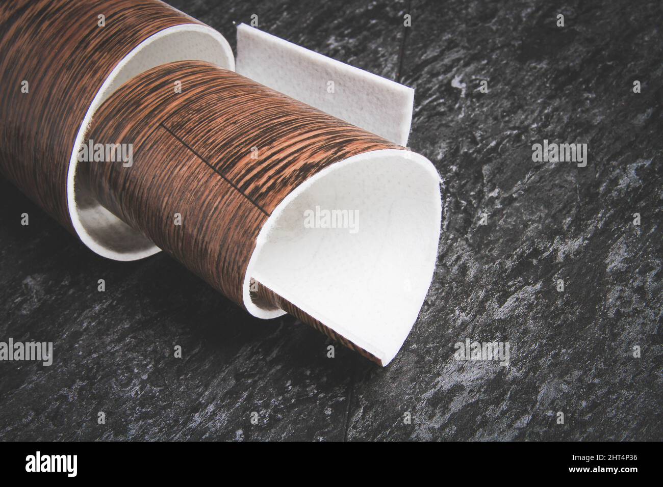 Linoleum. Roll of linoleum on a black background. Floor coverings ...