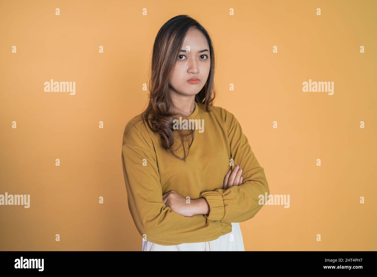 young woman stand cross hand with unhappy sad face Stock Photo - Alamy
