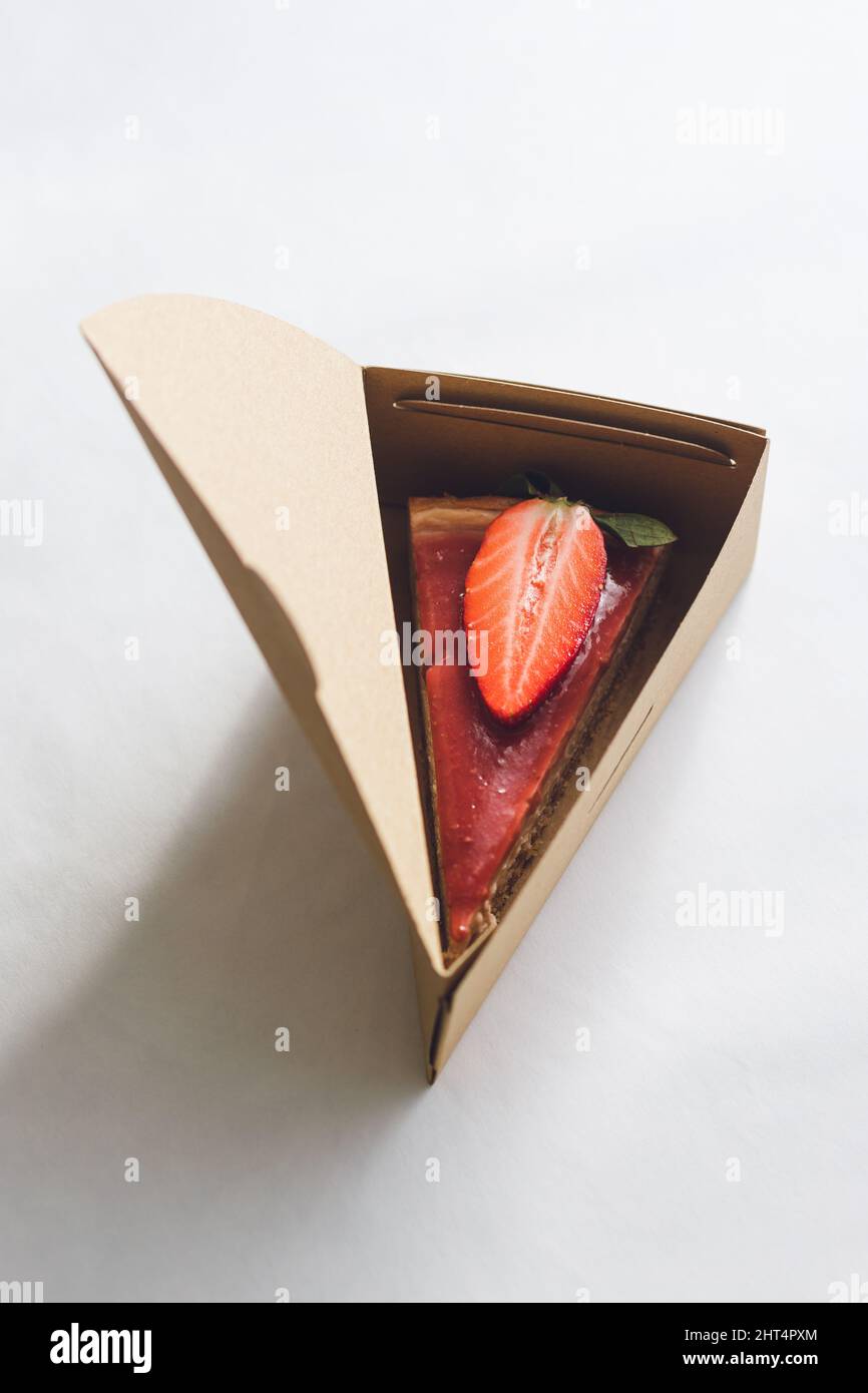 Top view of a Strawberry cheesecake in a triangular cake box Stock ...