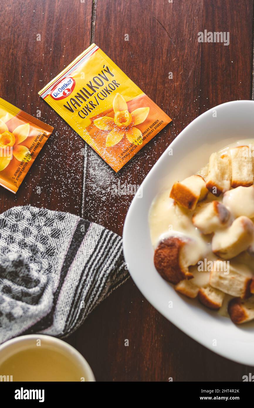 Vertical shot of baked yeast dumplings with dr. oetker vanilla cream ...
