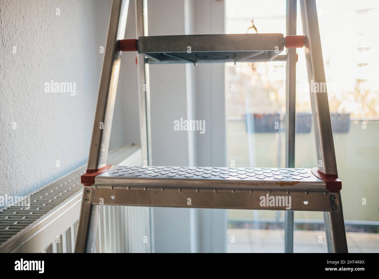 Metallic ladder indoors, with a view out of the window Stock Photo - Alamy