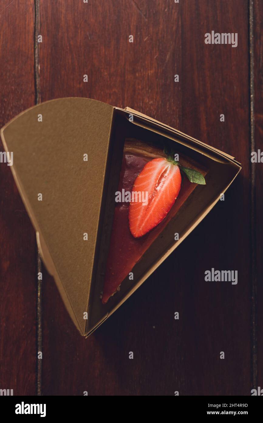 Top view of a Strawberry cheesecake in a triangular cake box Stock ...