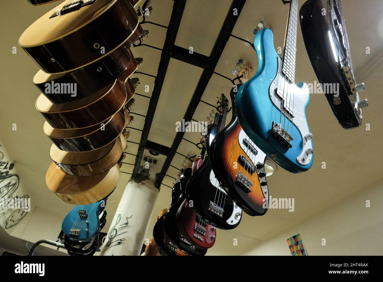 Low angle shot of different guitars on the display in a music store in ...