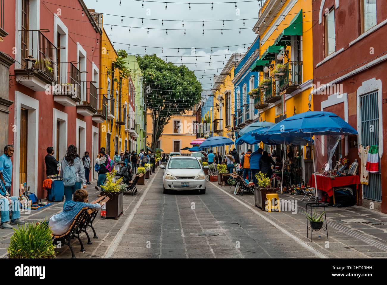 View of shops, stands, people and a car near Los Zapos market Stock ...