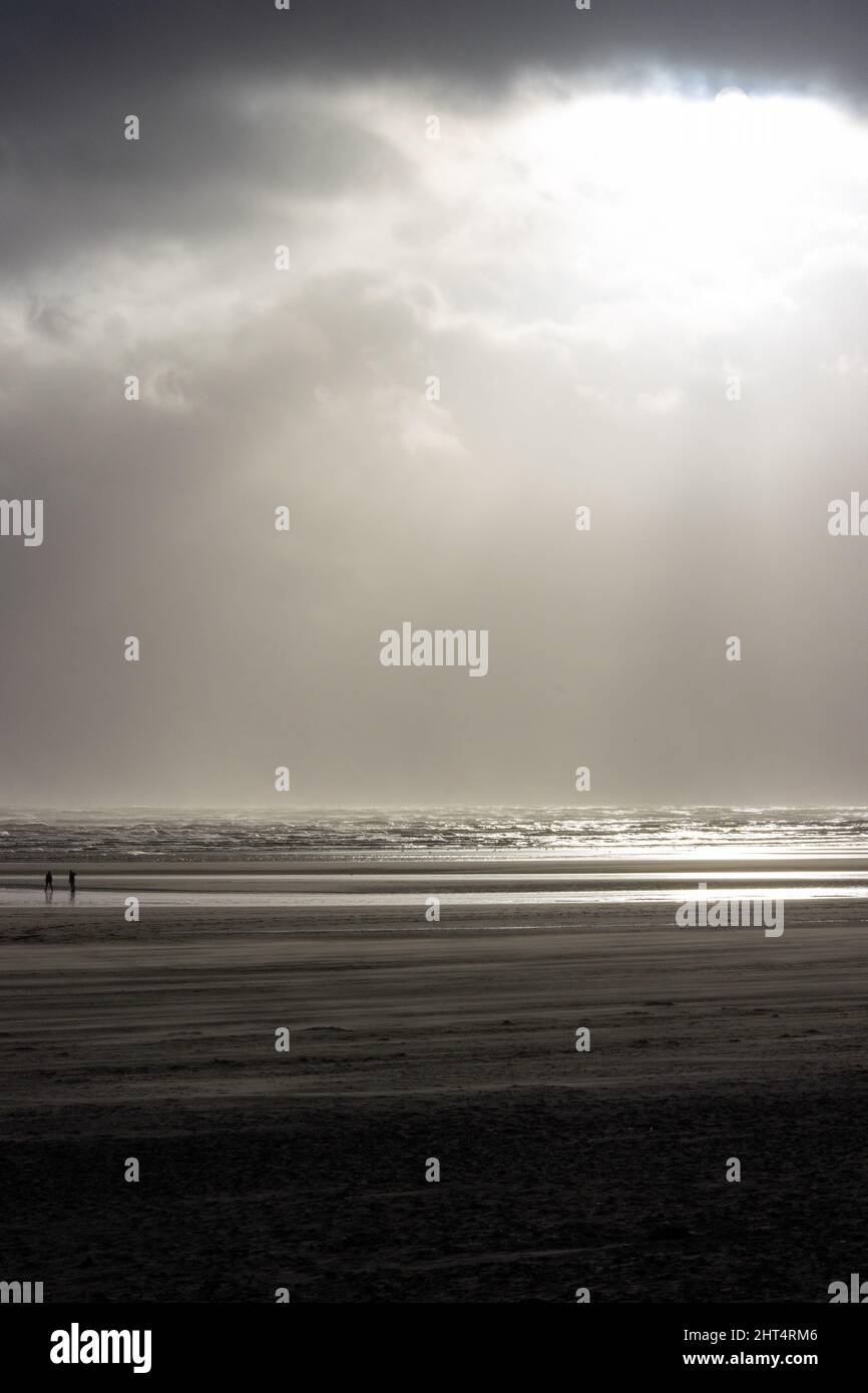 Vertical shot of the Camber Sands surrounded by the sea in Rye, England ...