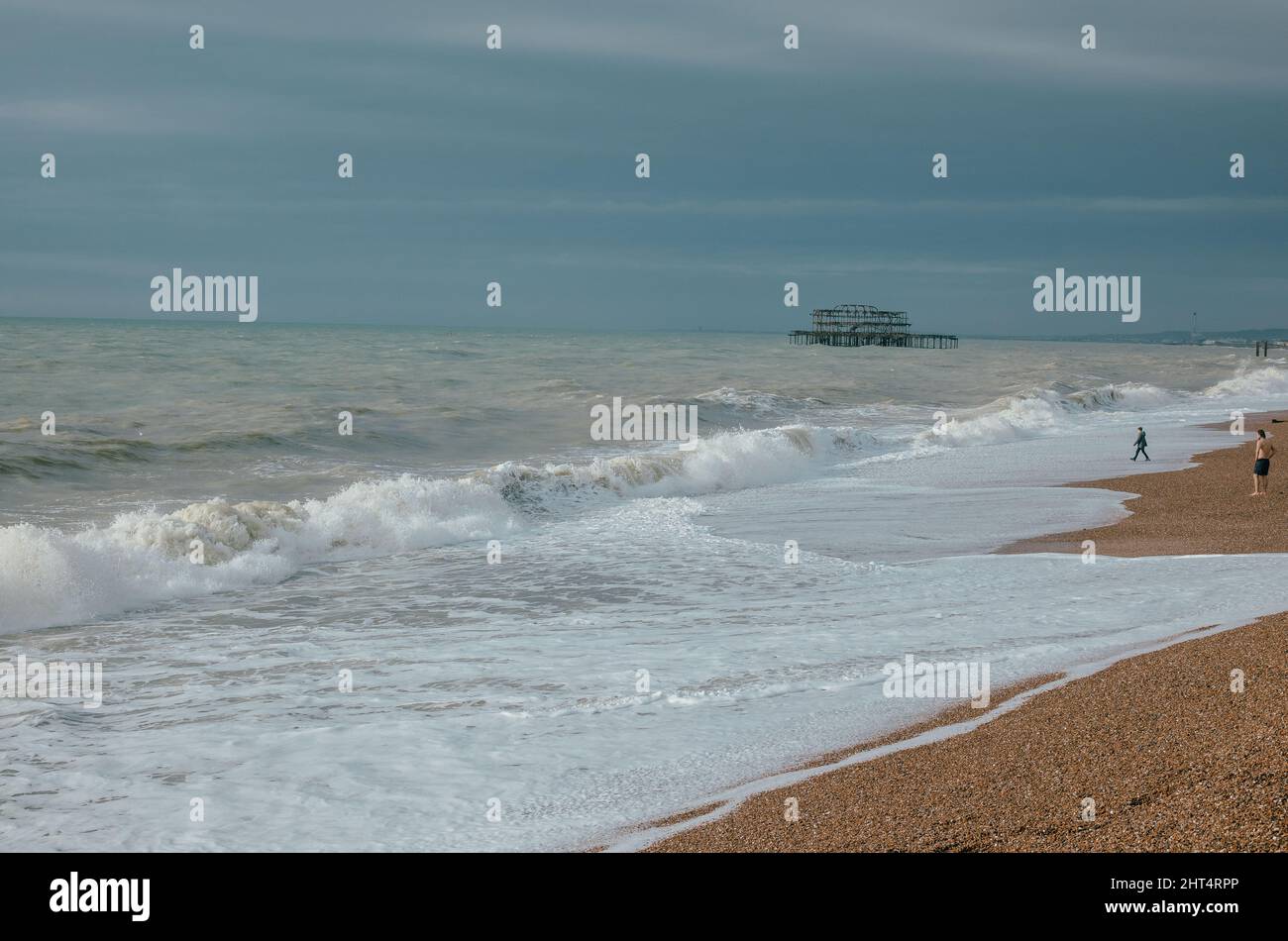 Landscape of the sea surrounding the Old Brighton Pier under a cloudy ...
