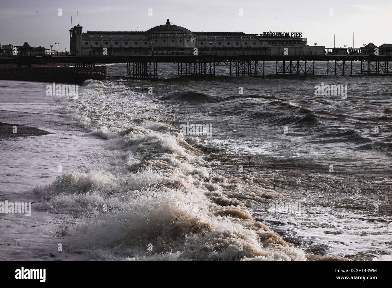 Landscape of the Brighton Palace Pier over the sea on a rainy day in ...