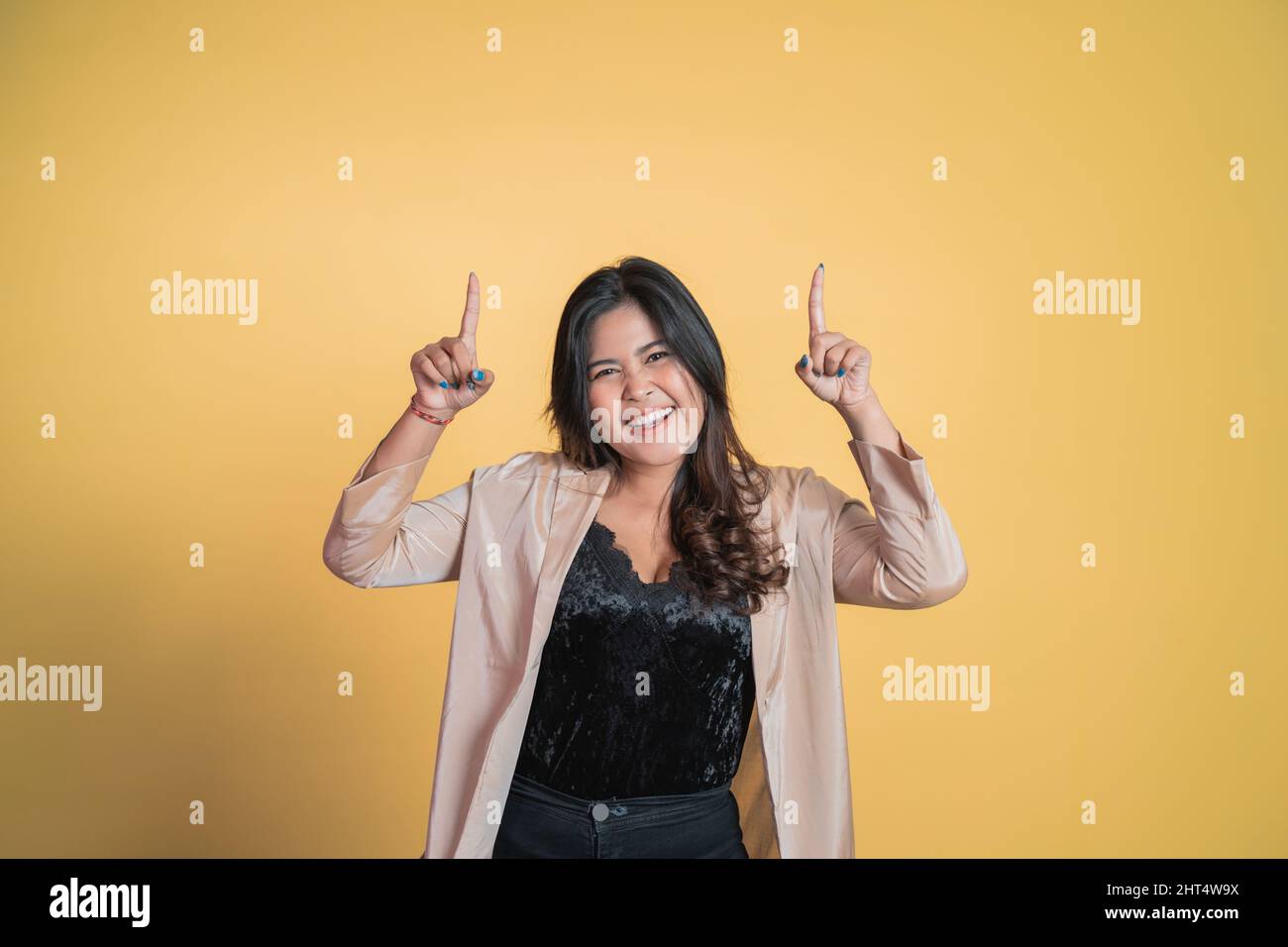young woman with two finger pointing up Stock Photo - Alamy