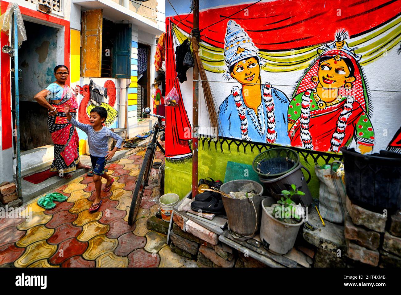 A woman and a kid seen in a colorful slum surroundings with beautiful ...
