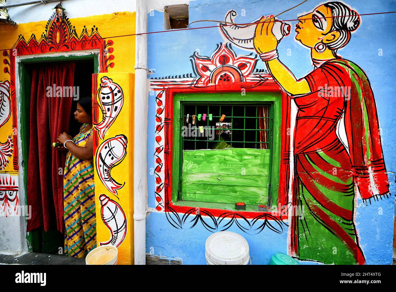 Daily life scene in a colorful slum surroundings with beautiful wall ...