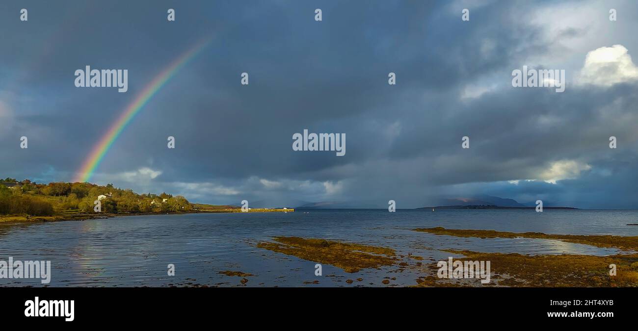Beautiful rainbow over the shore of the Isle of Skye in Scotland Stock ...