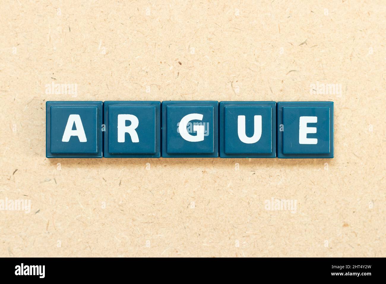 Tile alphabet letter in word argue on wood background Stock Photo - Alamy