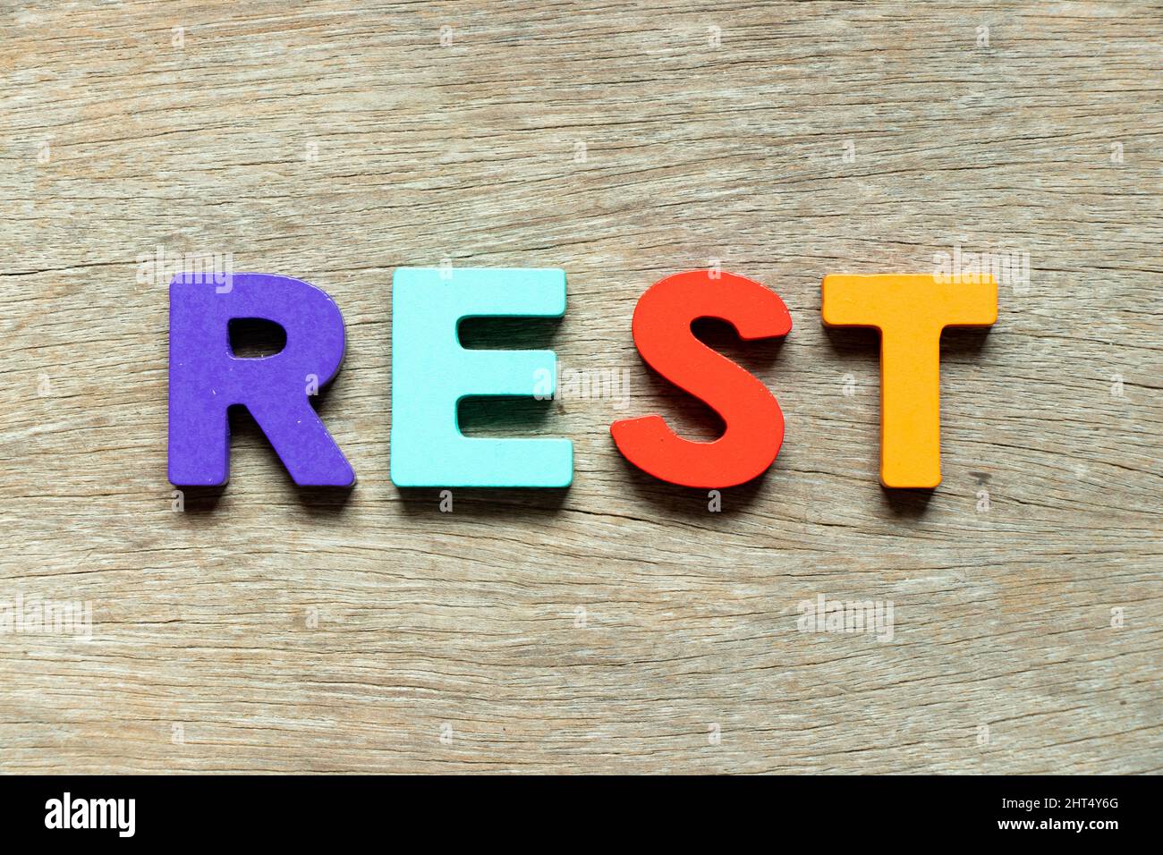 Color alphabet letter in word rest on wood background Stock Photo - Alamy