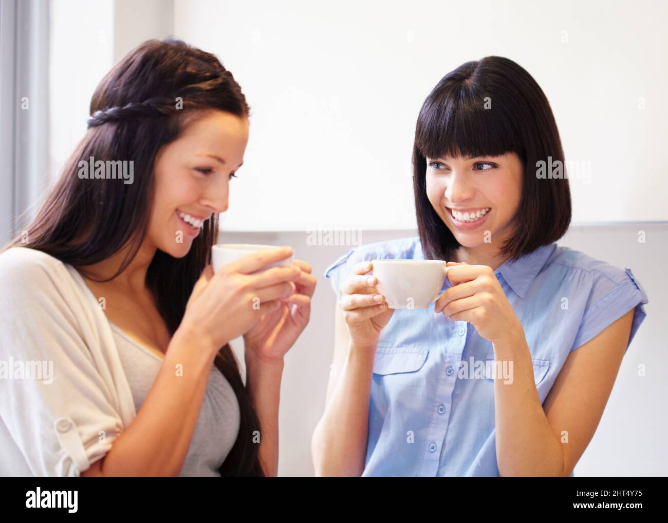 Happy pretty girlfriends talking over hi-res stock photography and ...