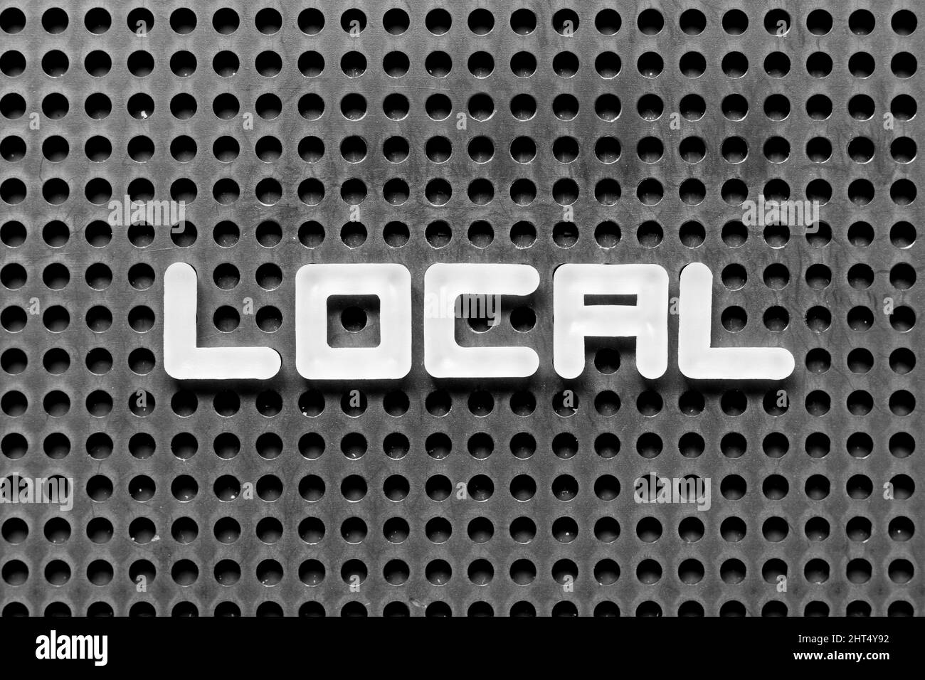 White alphabet letter in word local on black pegboard background Stock ...
