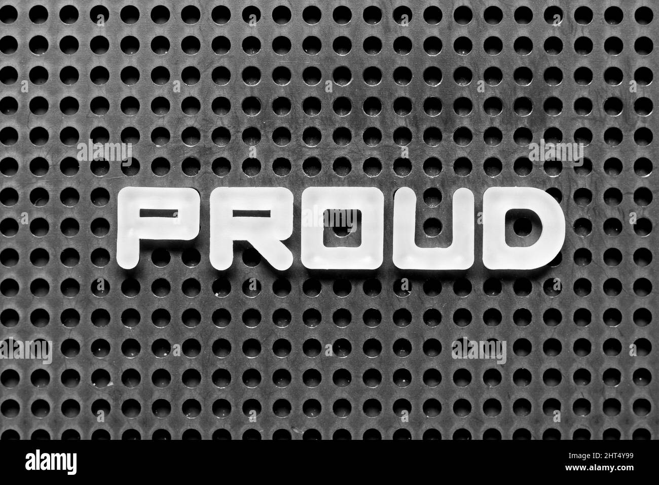 White alphabet letter in word proud on black pegboard background Stock ...