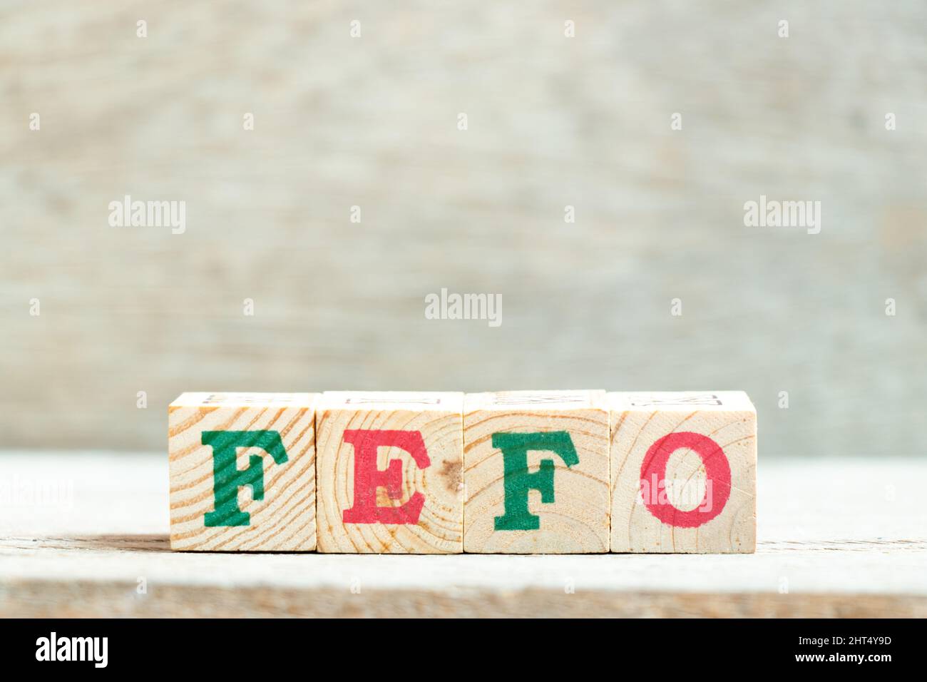 Alphabet letter block in word FEFO (first expired first out) on wood ...