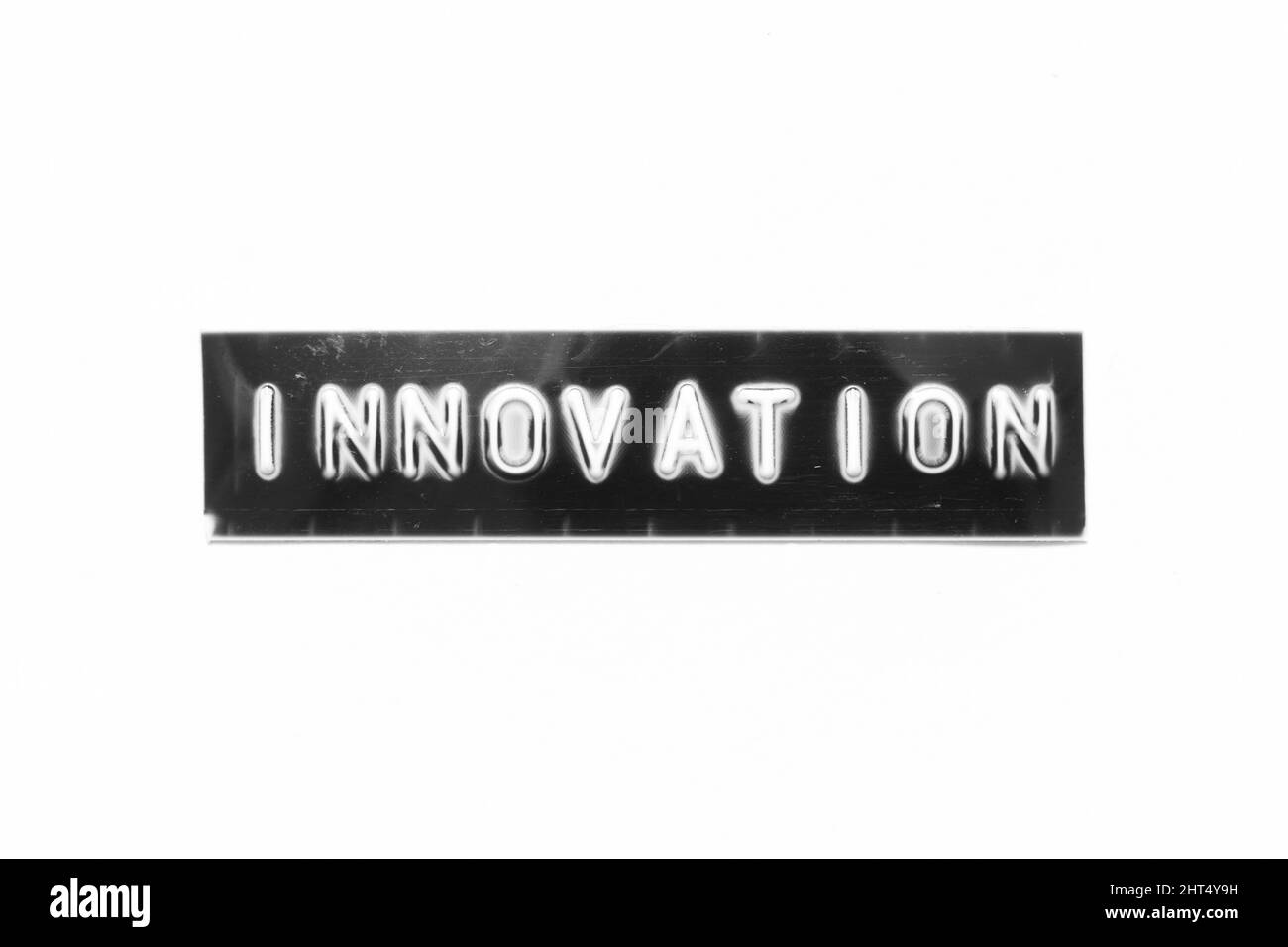 Embossed letter with word innovation in black banner on white paper ...