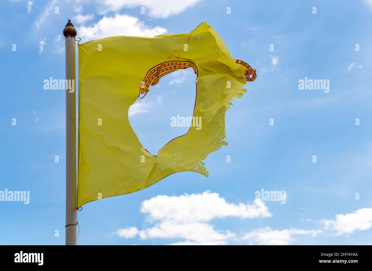 The damaged dhammacakka flag, the symbol of Buddhism in Thailand flying ...
