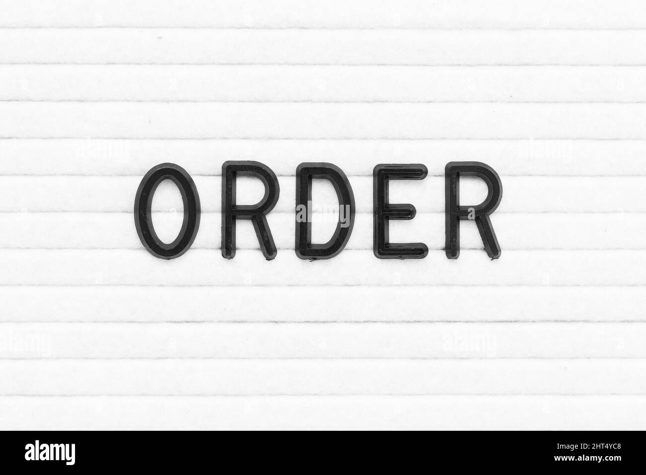 Black color letter in word order on white felt board background Stock ...