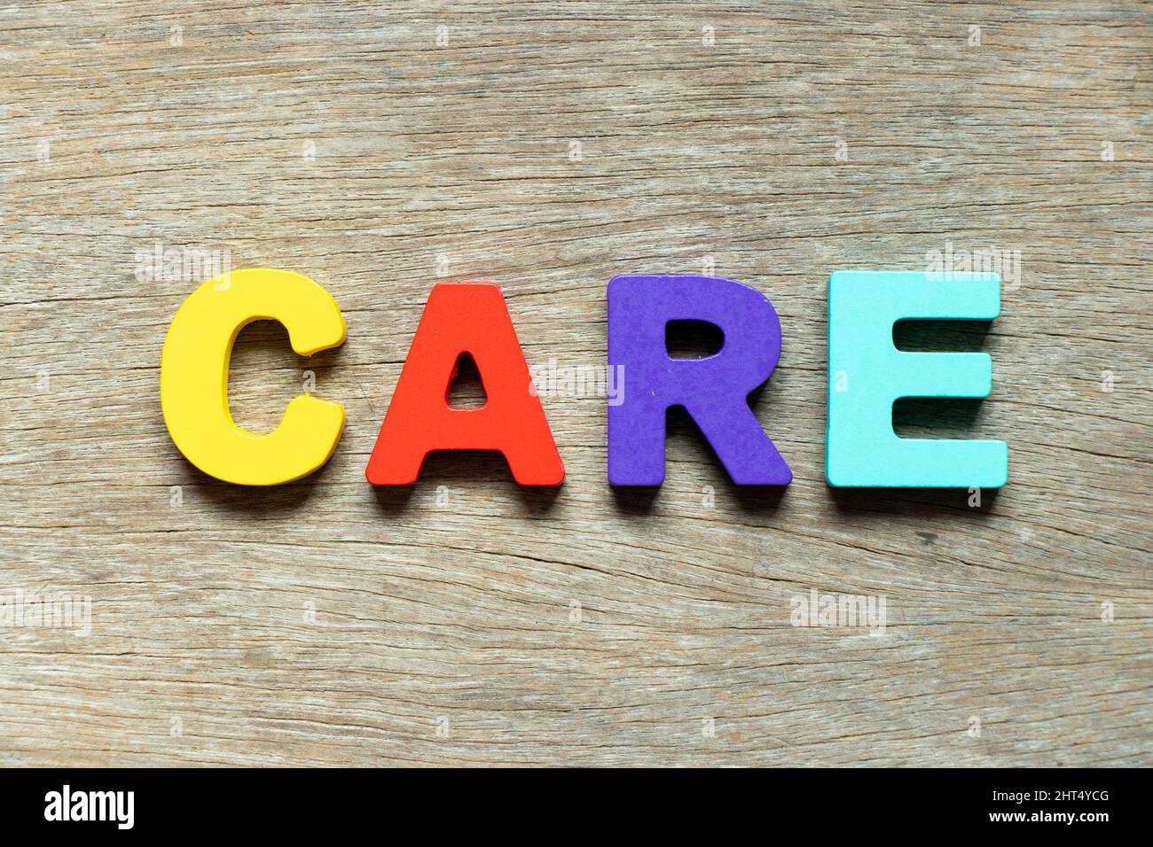 Color alphabet letter in word care on wood background Stock Photo - Alamy
