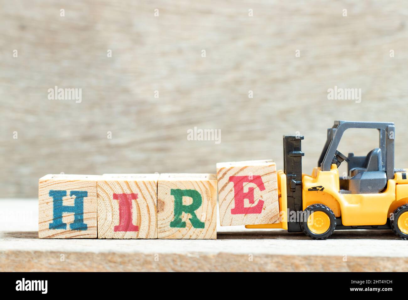 Toy forklift hold letter block e in word hire on wood background Stock ... Toy forklift hold letter block e in word hire on wood background Stock ...