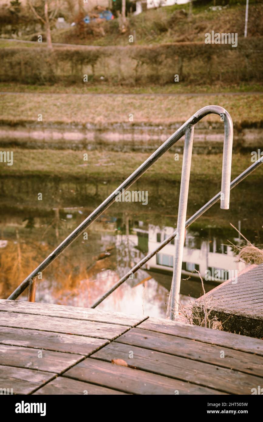 Closeup of stairs leading to a lake Stock Photo - Alamy