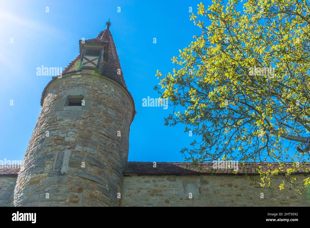 A low angle of an old medieval tower in Rothenburg ob der Tauber ...
