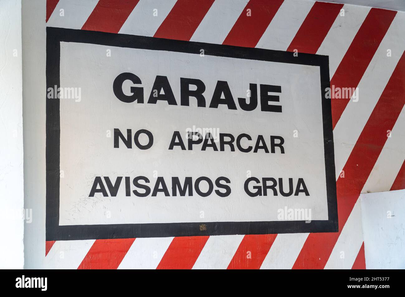 Garage warning sign- no parking, tow truck, on the wall at the entrance ...