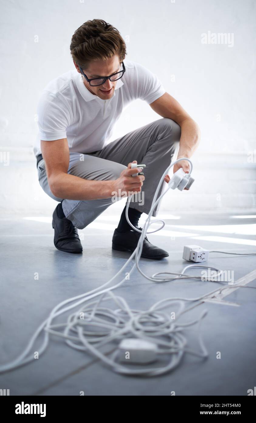 Giving your connection greater distance. A young man plugging in a plug ...