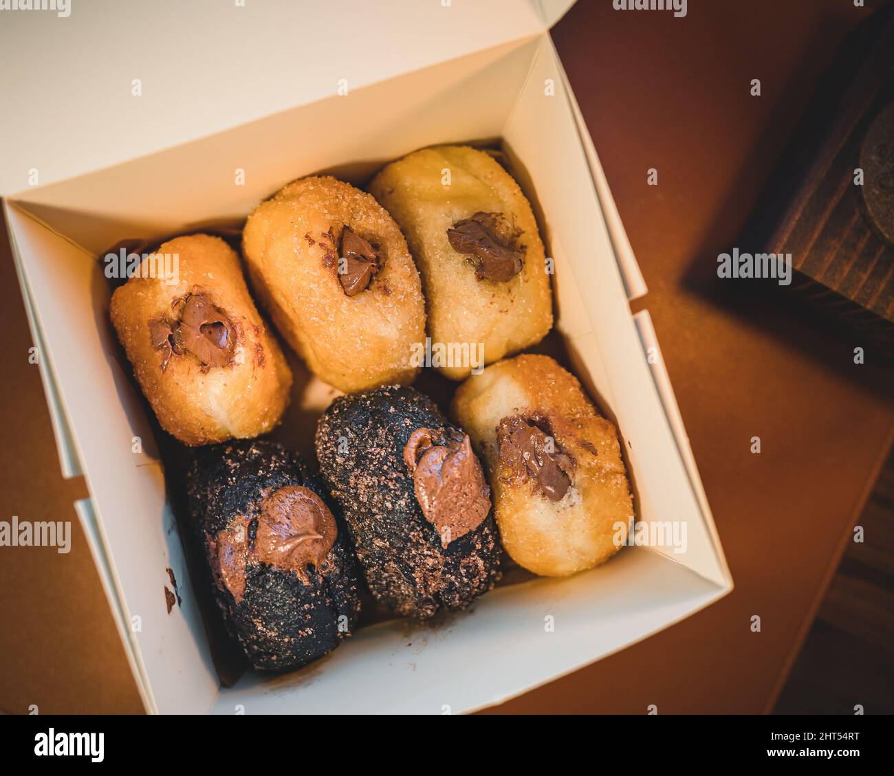 Top view of a box with cream filled donuts Stock Photo - Alamy