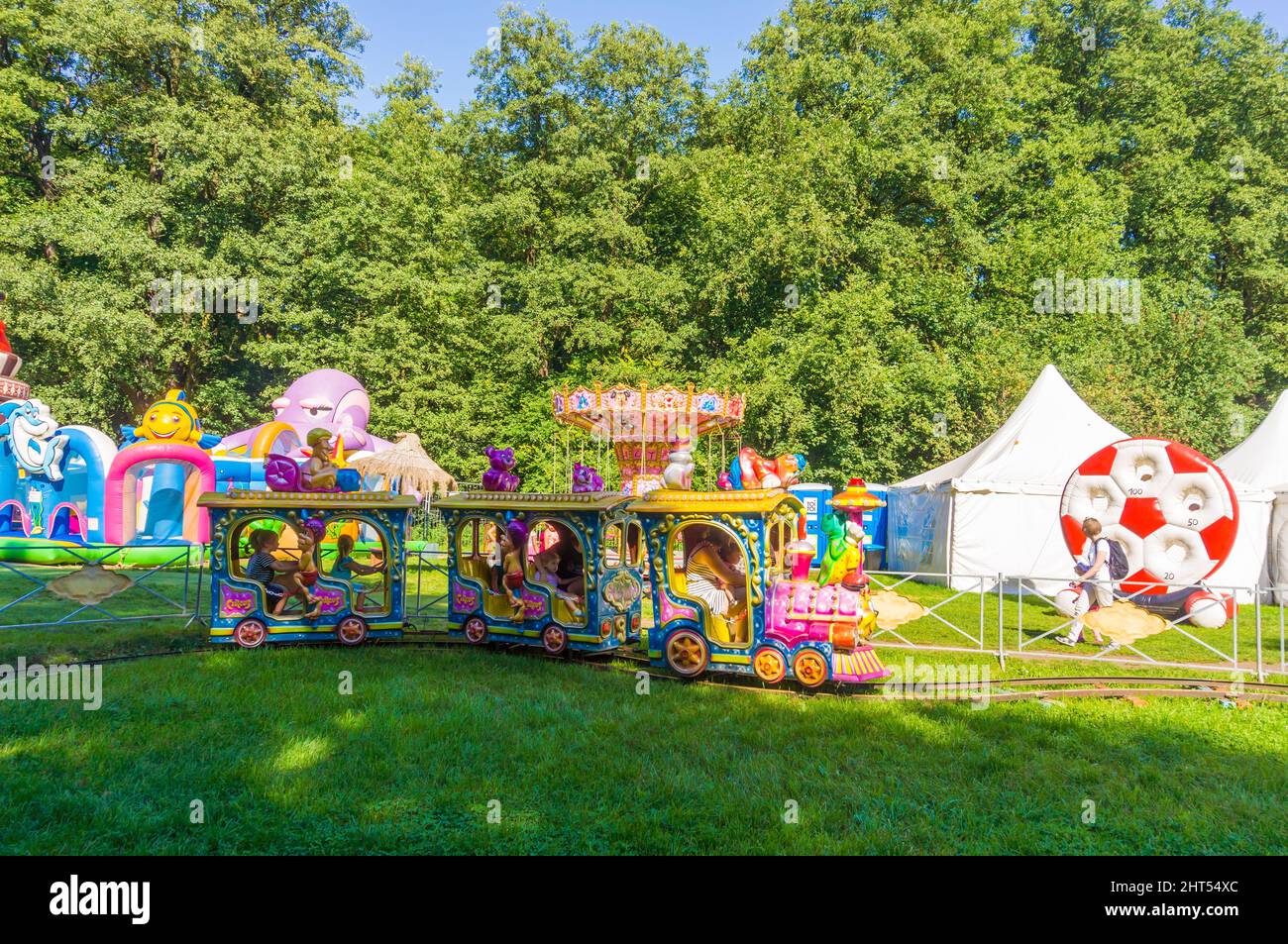 Colorful train attraction on track in the Frajda park Stock Photo - Alamy