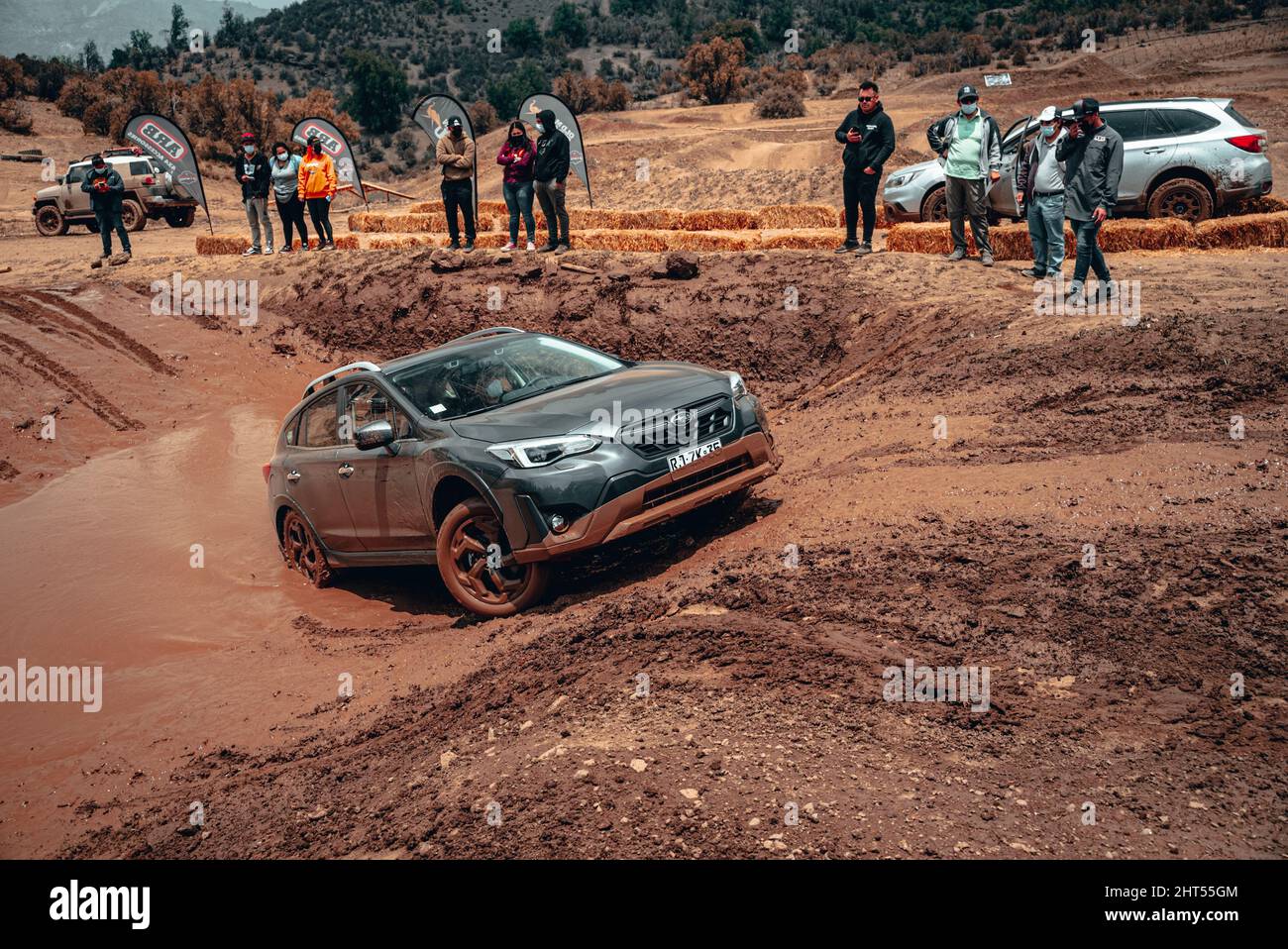 Gray offroad SUV passing obstacles at a muddy offroad course in ...