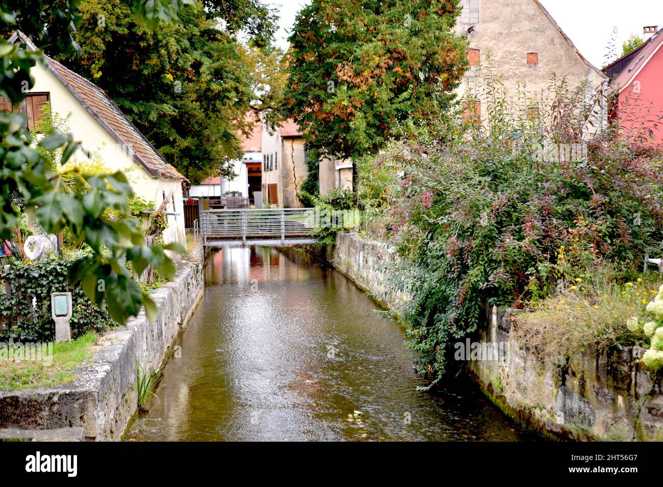 Beautiful shot of a water canal in the middle of buildings flowing ...