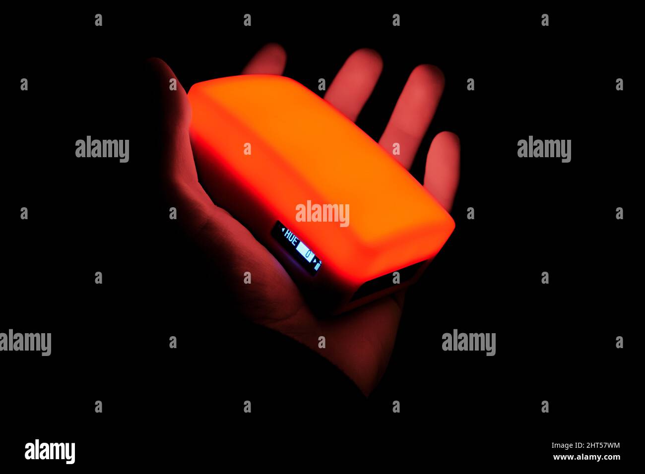 Hand holding a lighting color changing thermometer Stock Photo - Alamy