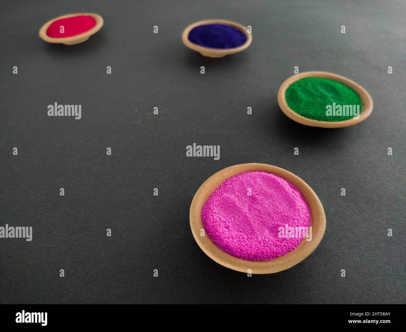 colorful powders for holi on clay pots on occasion of indian festival ...