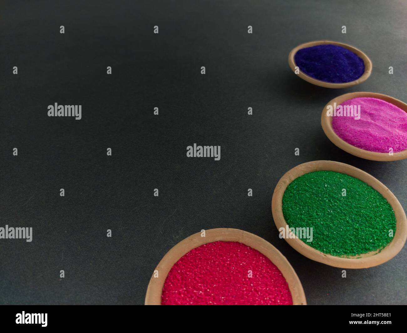 colorful powders for holi on clay pots on occasion of indian festival ...