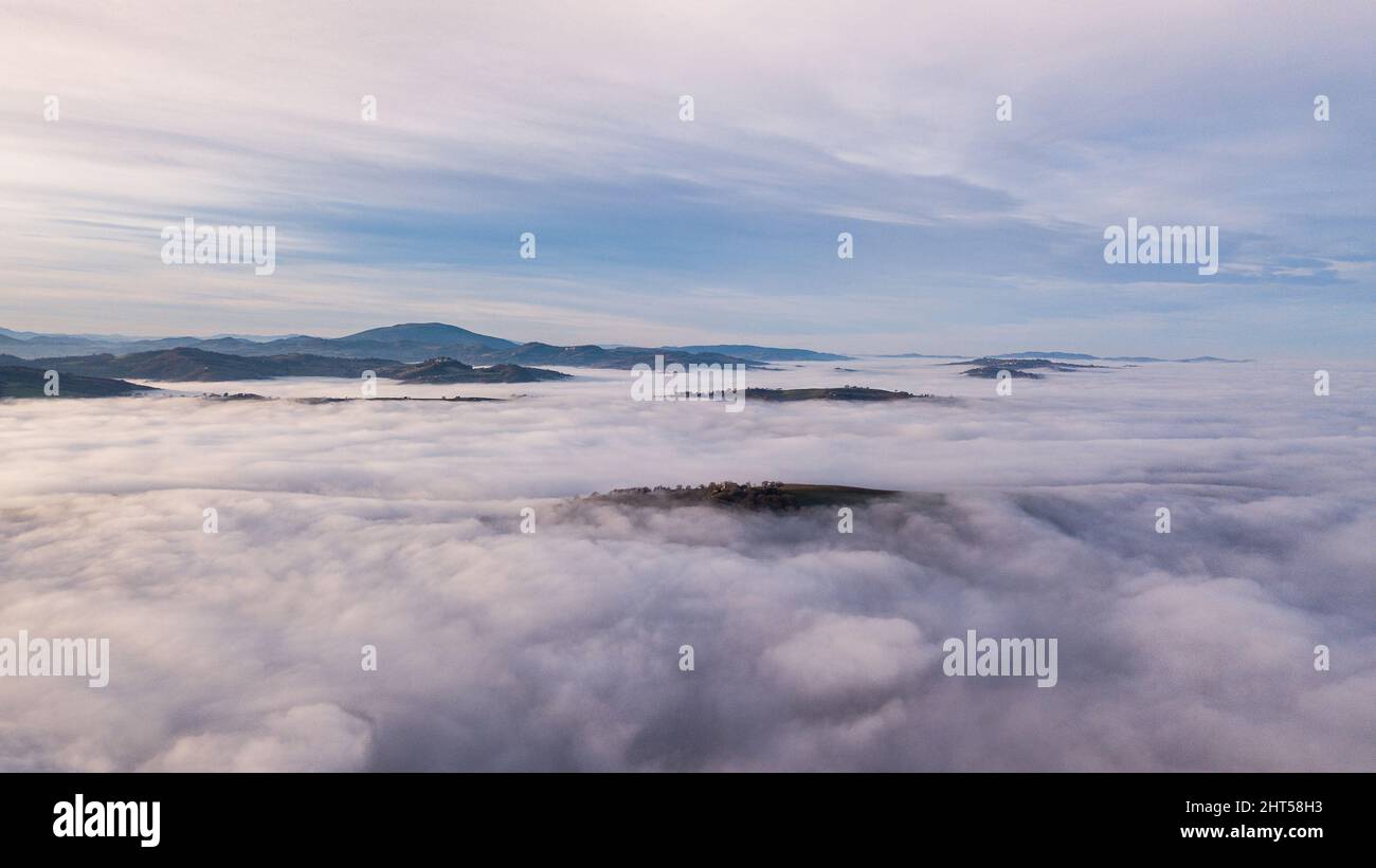 Aerial view of landscape surrounded by fog Stock Photo - Alamy