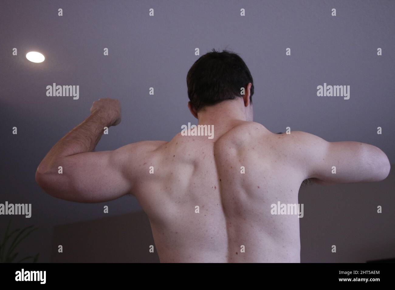 a man flexing back in selfie type photo Stock Photo - Alamy