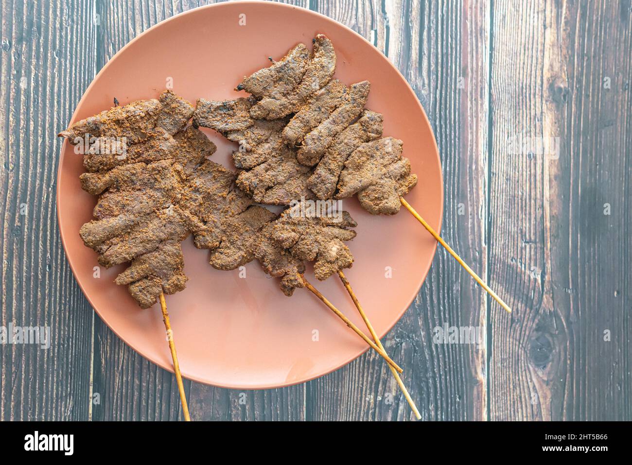Nigerian spicy grilled Suya snack on a stick ready to eat Stock Photo ...