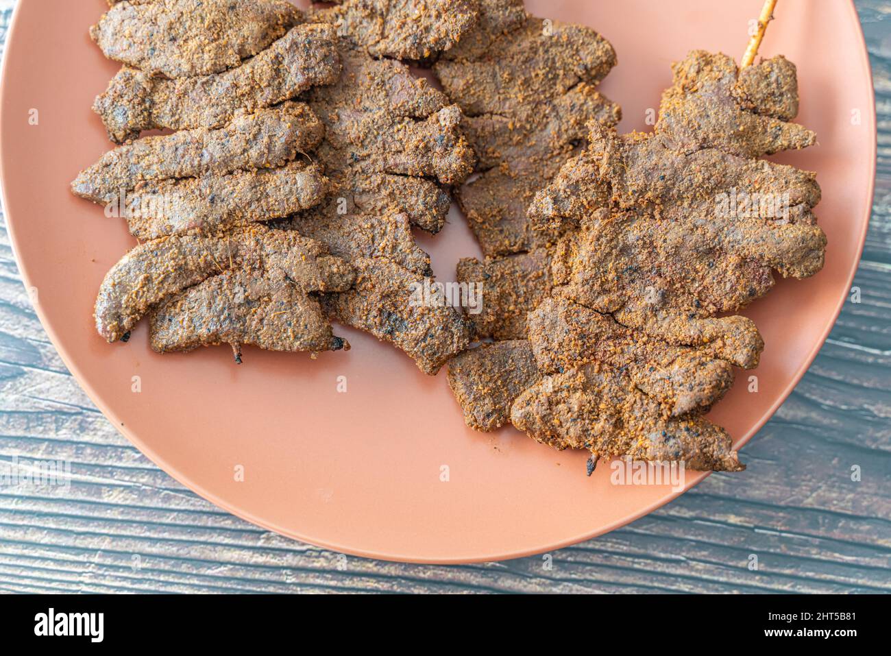 Nigerian spicy grilled Suya snack on a stick ready to eat Stock Photo ...