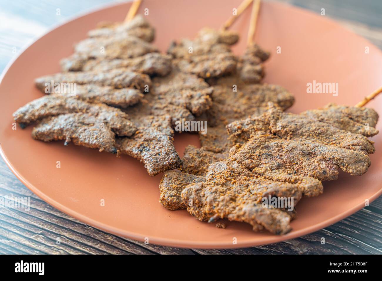Nigerian spicy grilled Suya snack on a stick ready to eat Stock Photo ...