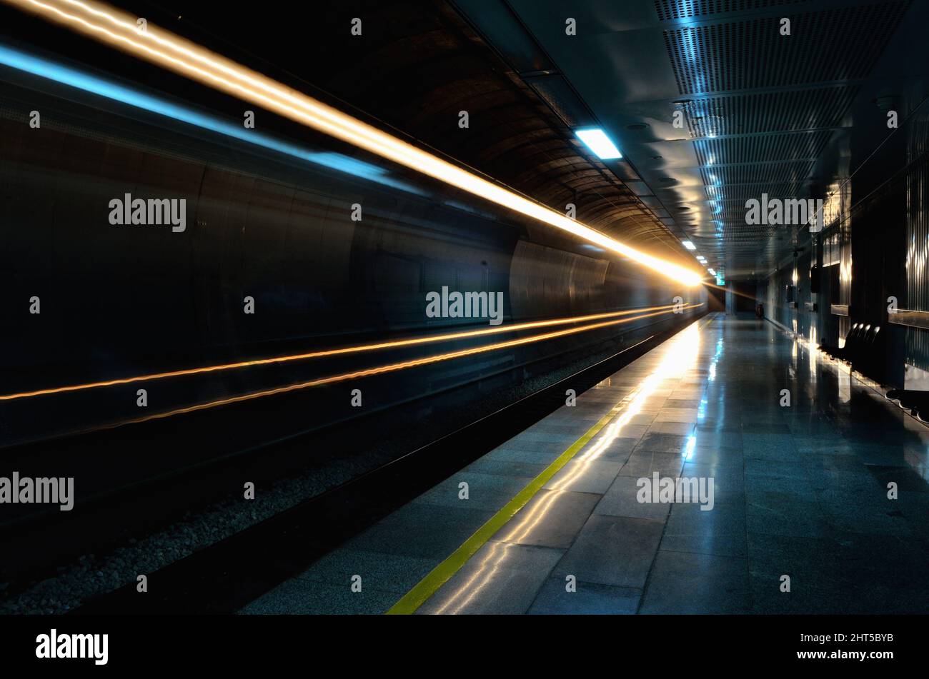 Long exposure shot of passing train lights at a station Stock Photo - Alamy