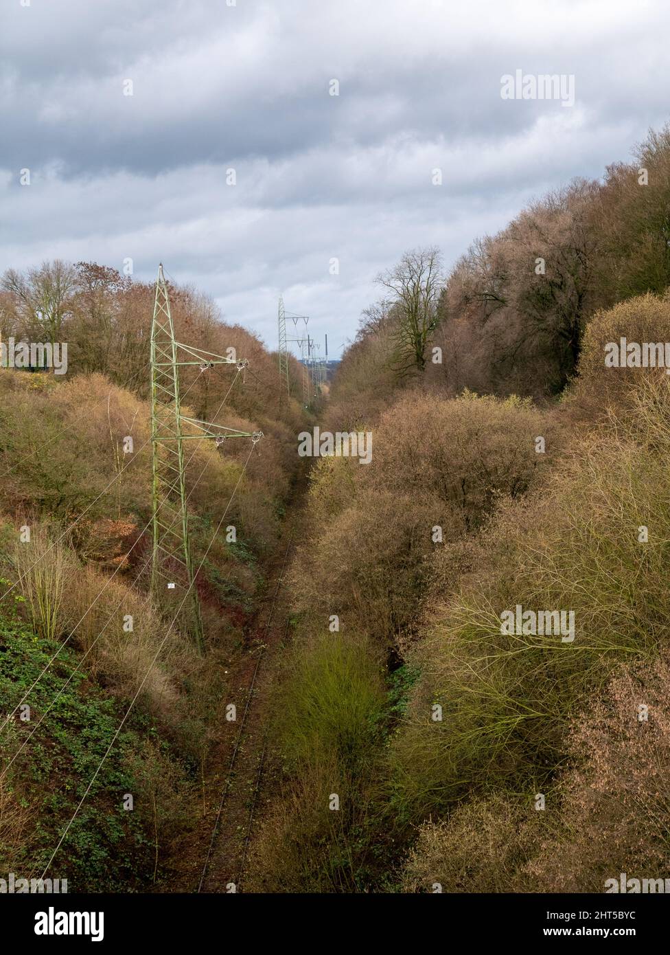 Vertical shot of electric power lines with insulators on a hill Stock ...