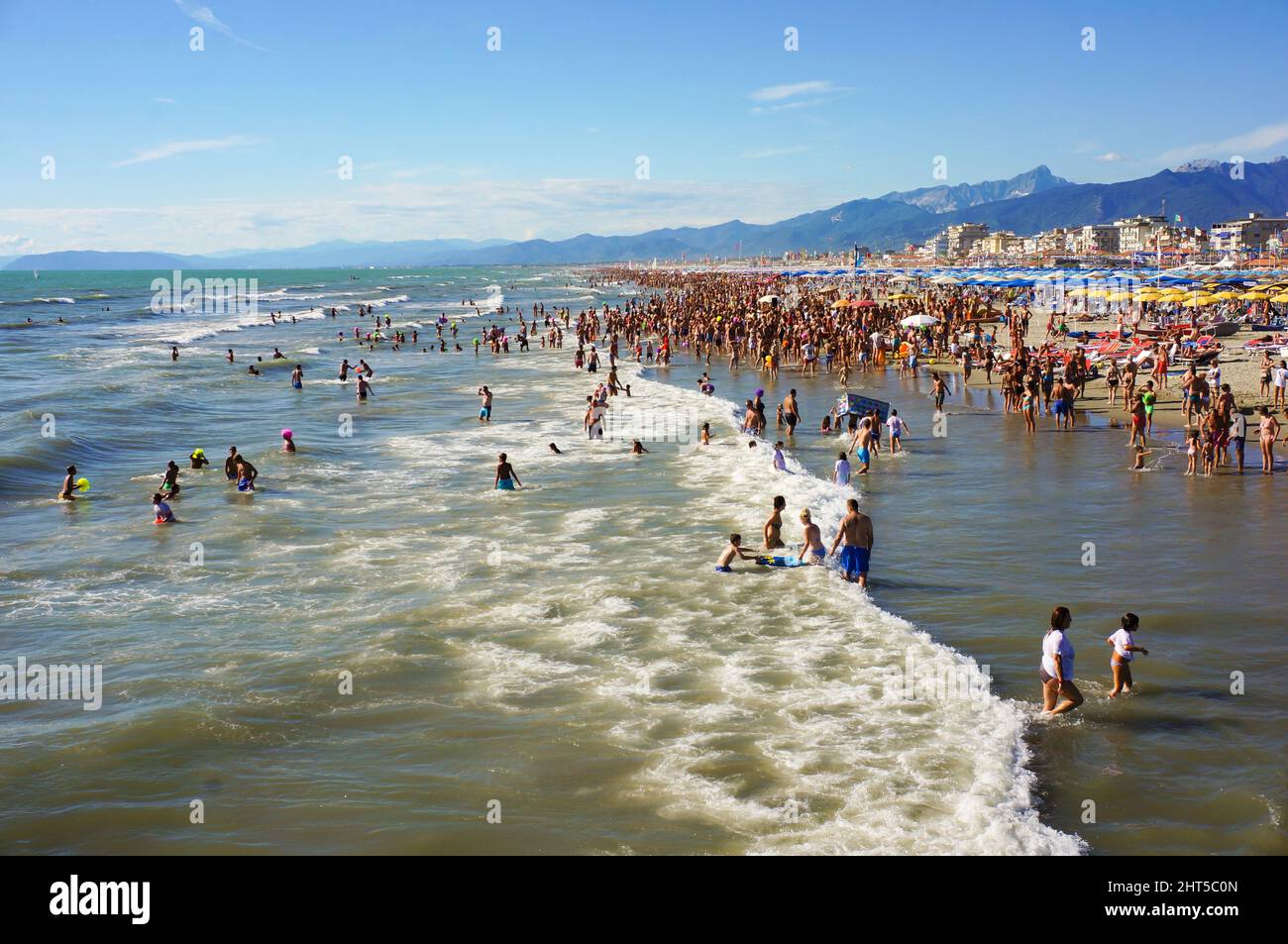 Lot of people relaxing at the beach on a warm summer day in Lido di ...